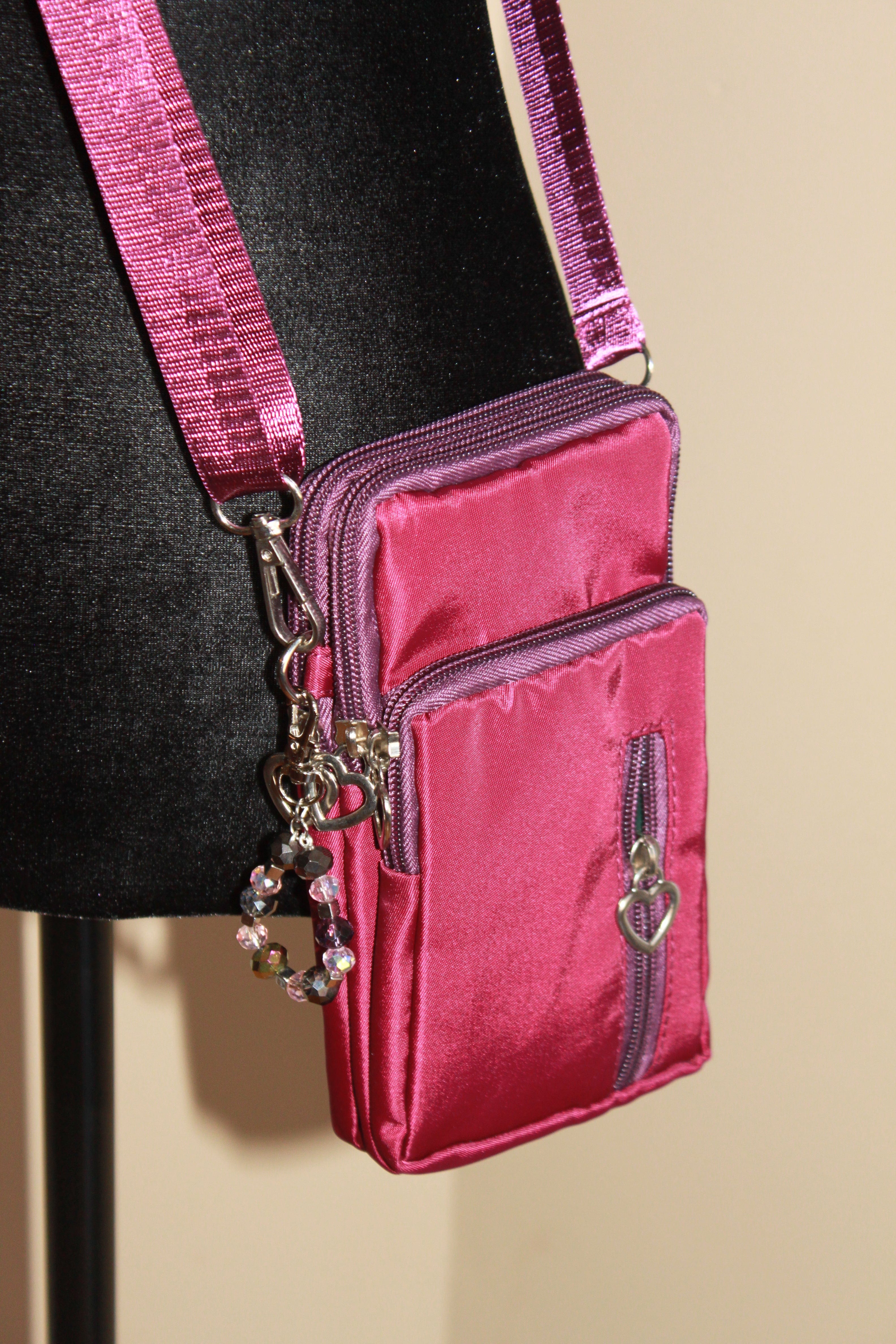 Small burgundy crossbody bag w/adjustable strap and pretty bag charm